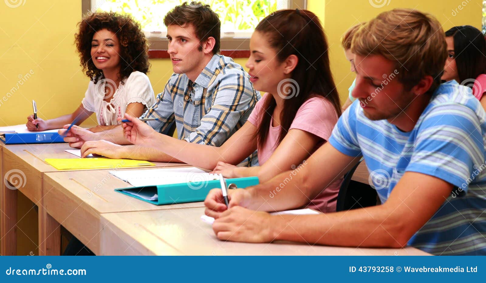 Happy Students Sitting in a Line Listening in Classroom Stock Footage ...