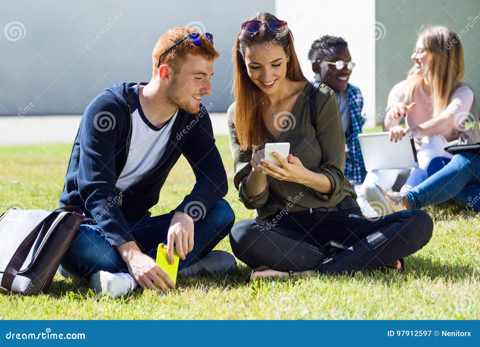 Happy Students Sitting Outside on Campus at the University. Stock Image ...