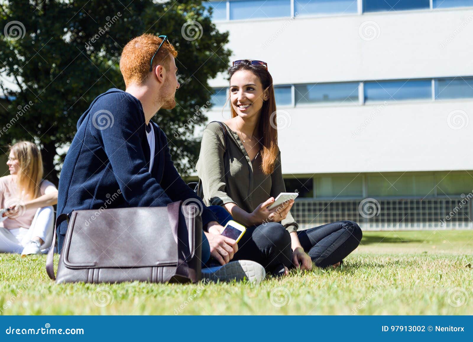 Happy Students Sitting Outside on Campus at the University. Stock Photo ...