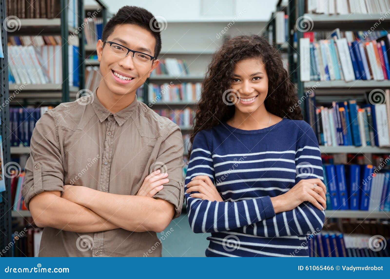 Happy Students Standing in Library Stock Photo - Image of picking ...