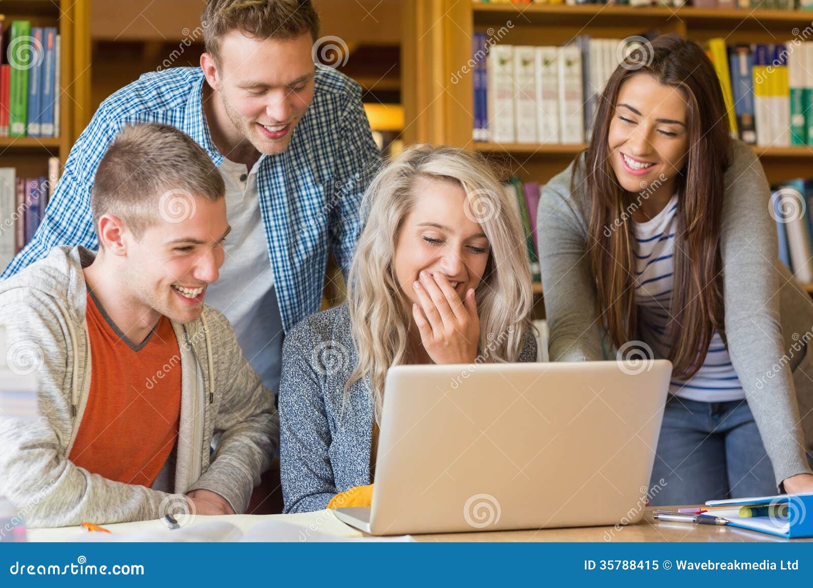 Happy Students Using Laptop at Desk in Library Stock Image - Image of ...