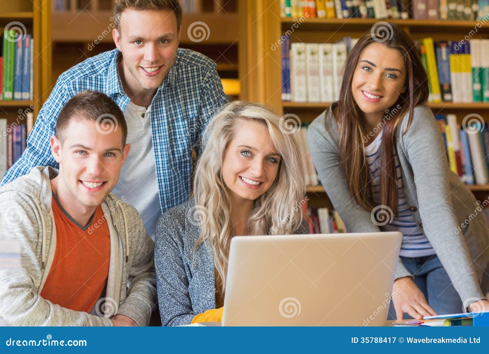Happy Students Using Laptop at Desk in Library Stock Image - Image of ...