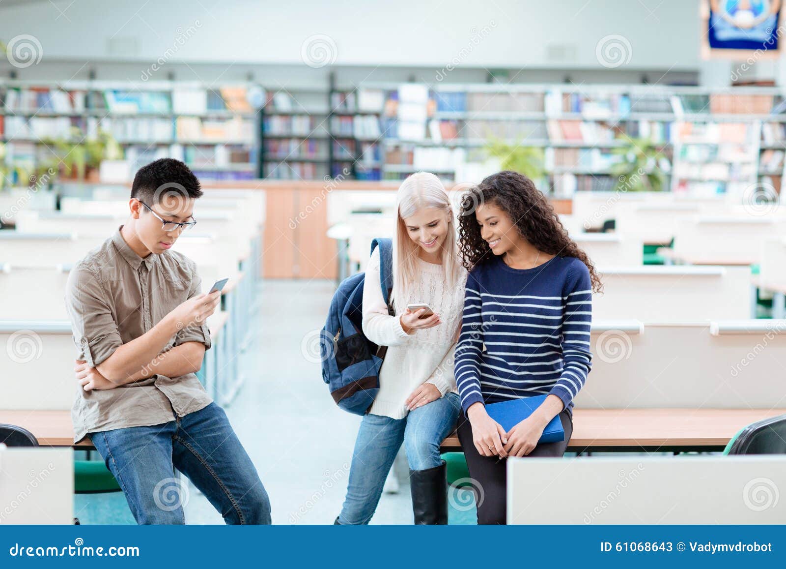 Happy Students Using Smartphones in the Library Stock Image - Image of ...