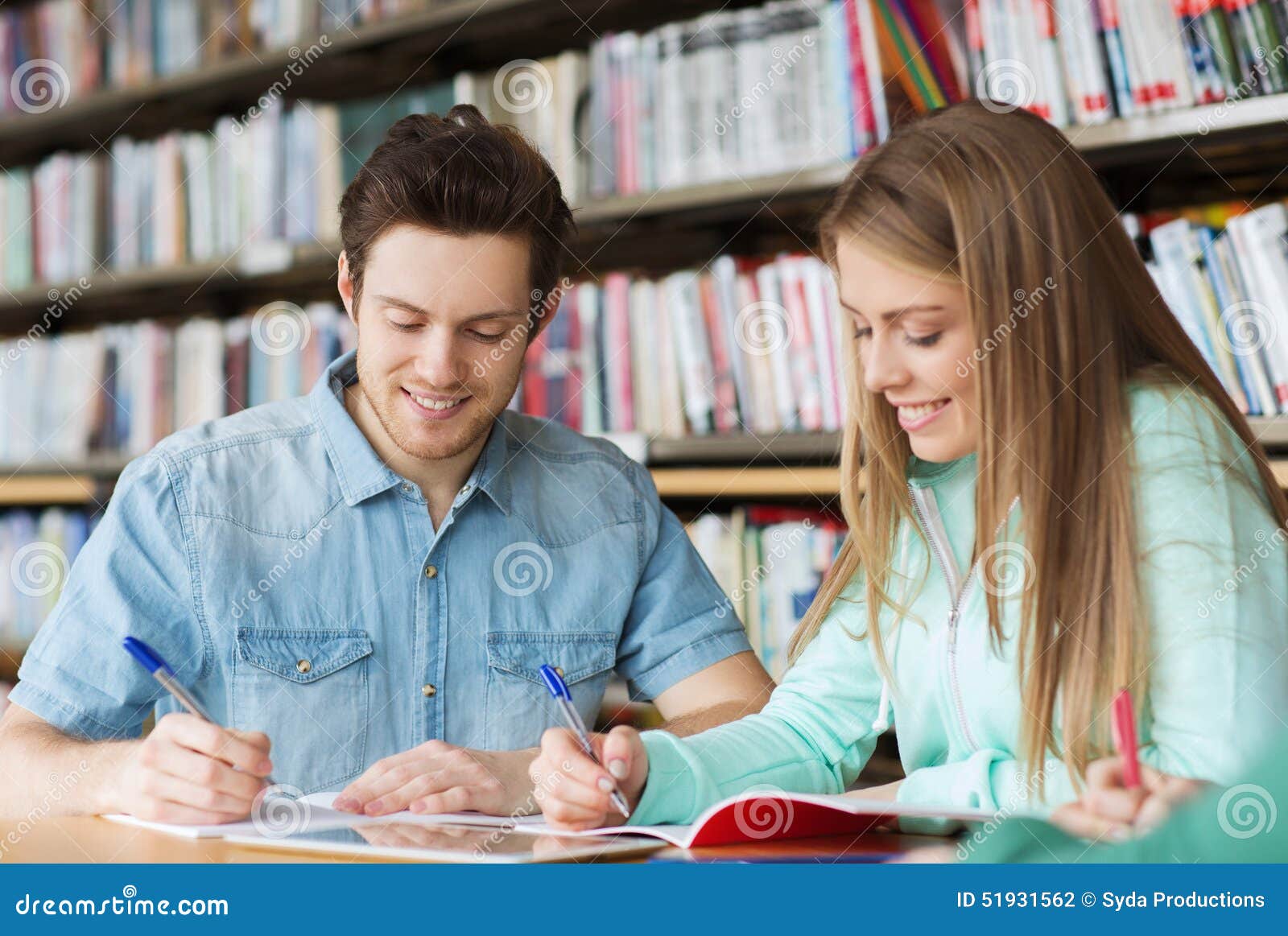 Happy Students Writing To Notebooks in Library Stock Photo - Image of ...