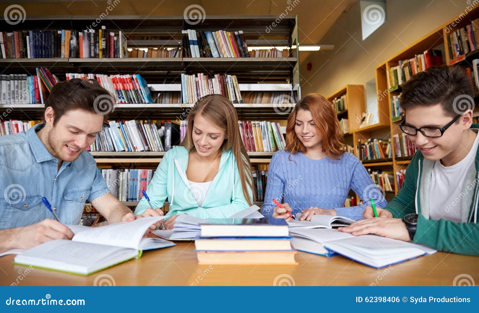 Happy Students Writing To Notebooks in Library Stock Photo - Image of ...