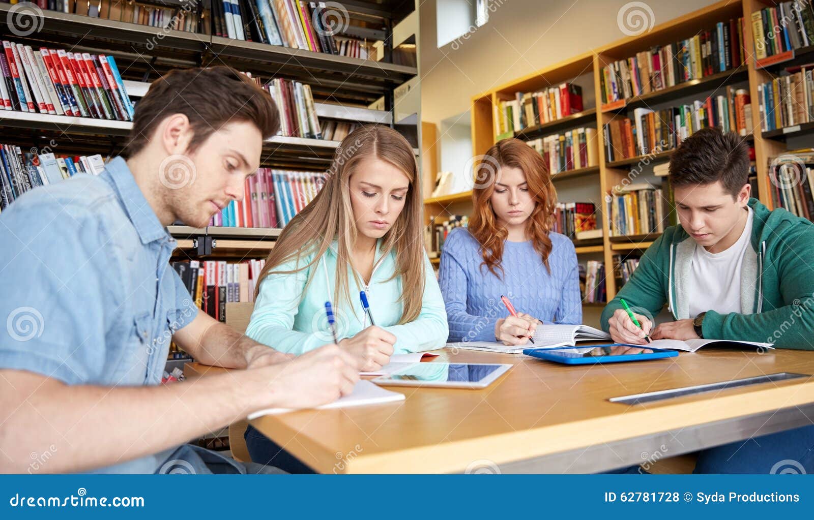 Happy Students Writing To Notebooks in Library Stock Photo - Image of ...
