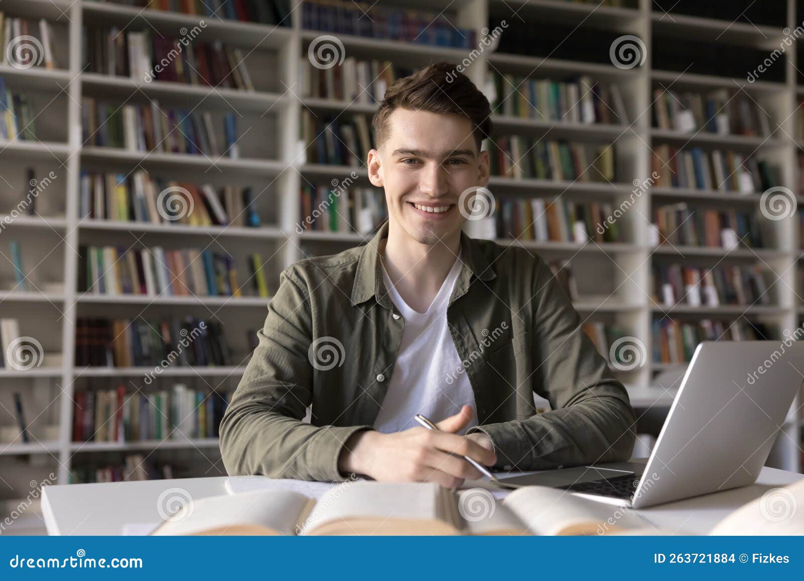 Happy Successful College Student Guy Working on Article in Library ...