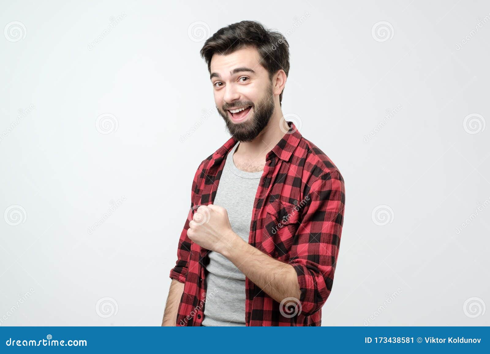 Happy Successful Young Man Screaming Yes And Raising Clenched Fists