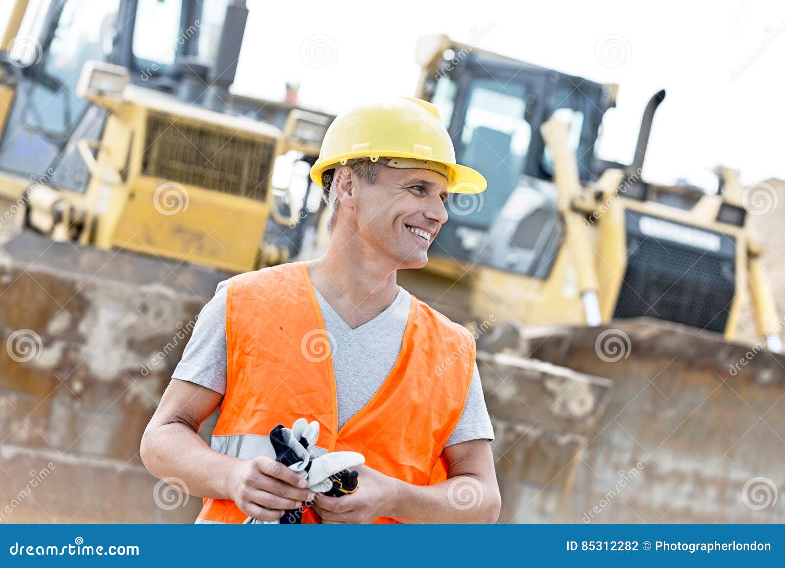 Happy Supervisor Looking Away at Construction Site Stock Photo - Image ...