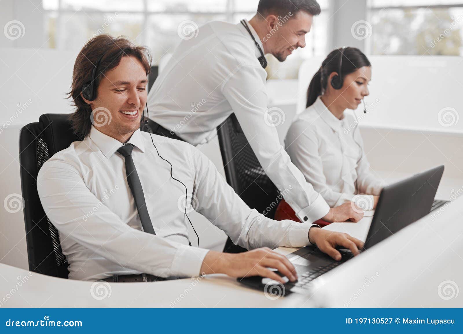 Happy Support Agent Using Laptop Near Colleagues Stock Image - Image of ...