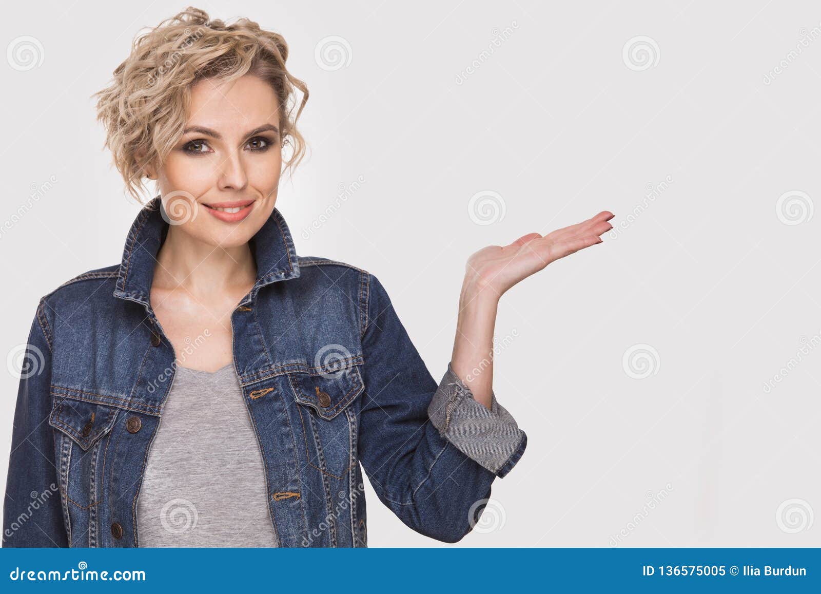 Happy Surprised Blonde Young Female Smiling Broadly At Camera Pointing