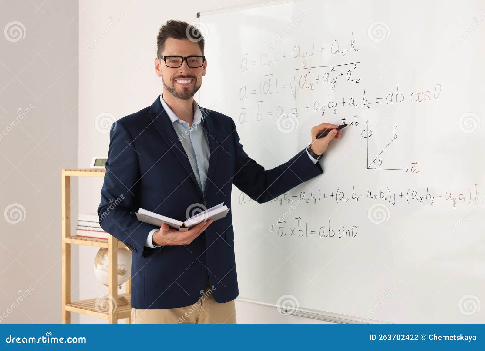 Happy Teacher with Book Explaining Mathematics at Whiteboard in ...