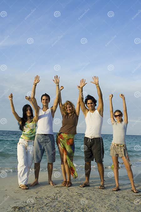Happy team on the beach stock photo. Image of conceptual - 4900252
