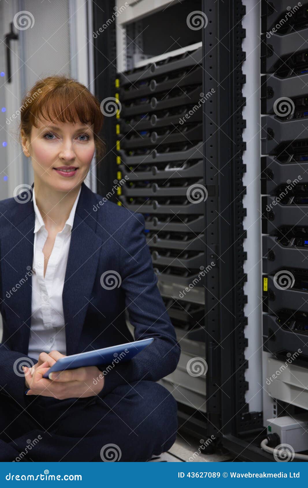 Happy Technician Sitting on Floor beside Server Tower Using Tablet Pc ...