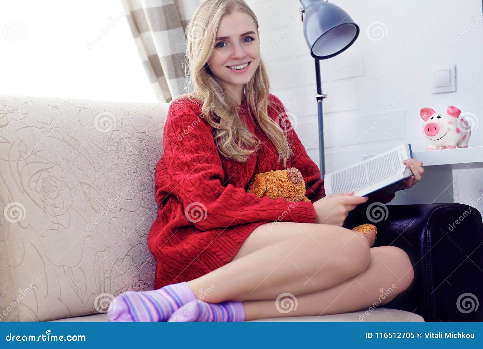 Happy Caucasian Teen Girl Resting On Sofa At The Living Room While