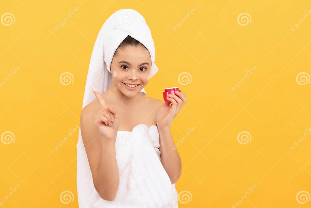 Happy Teen Girl In Shower Towel Applying Facial Cream Copy Space Stock