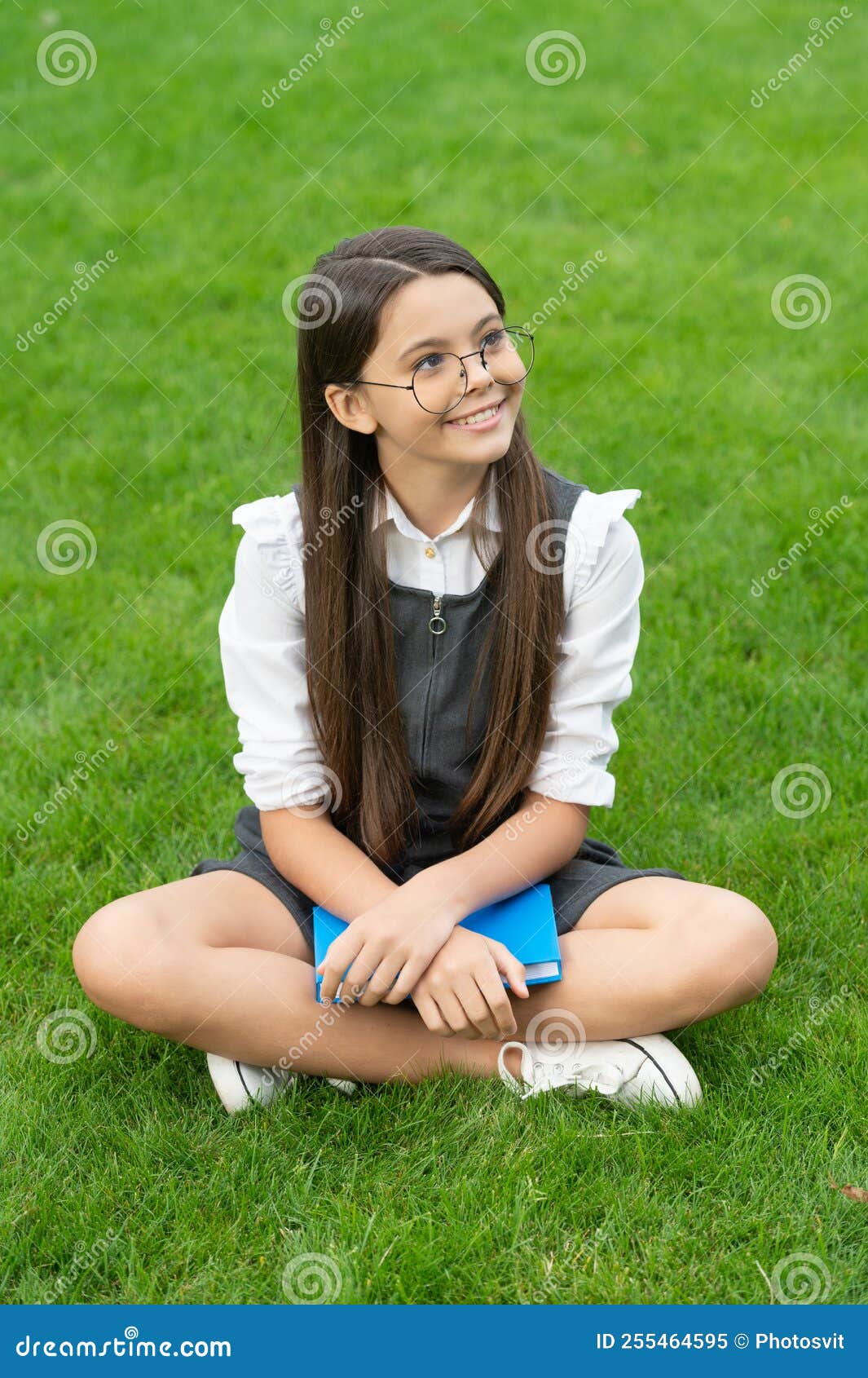 Happy Teenage School Girl Sitting Legs Crossed on Grass. School and ... Happy Teenage School Girl Sitting Legs Crossed on Grass. School and ...