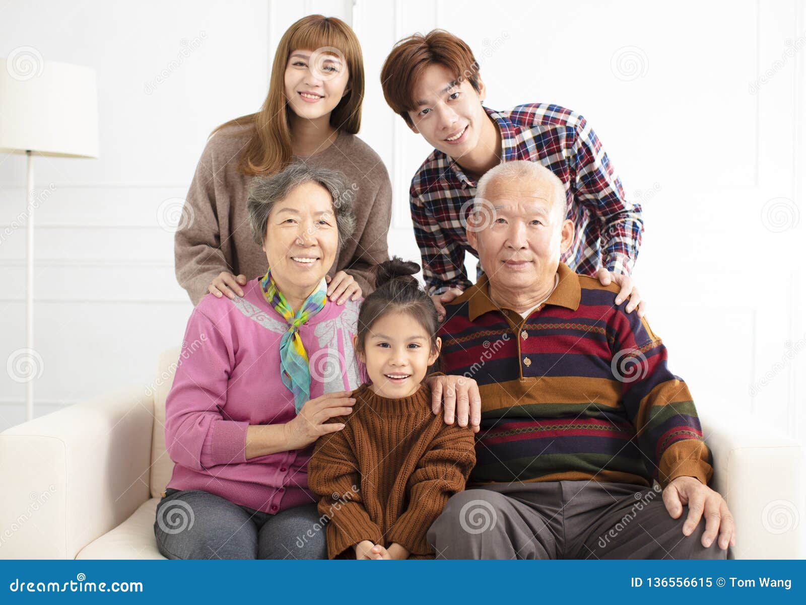 Happy asian family on sofa stock image. Image of people - 136556615