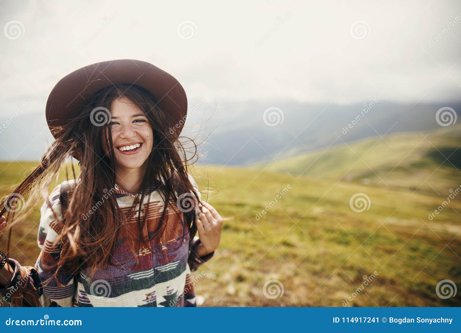 Happy Traveler Hipster Girl With Windy Hair Smiling Standing O Stock