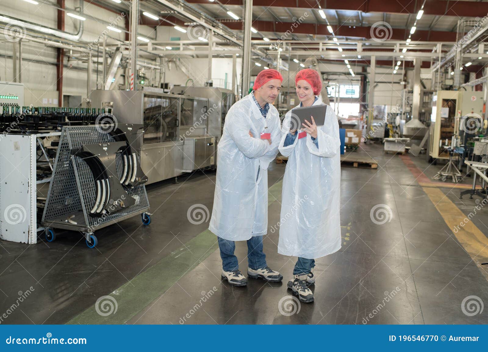Happy Two Factory Workers in Uniform Examining Sample Stock Photo ...
