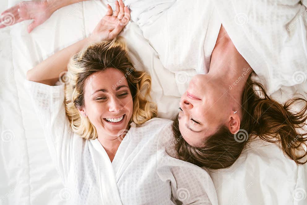 Happy Two Friends Caucasian Young Women In White Bathrobes Enjoying And