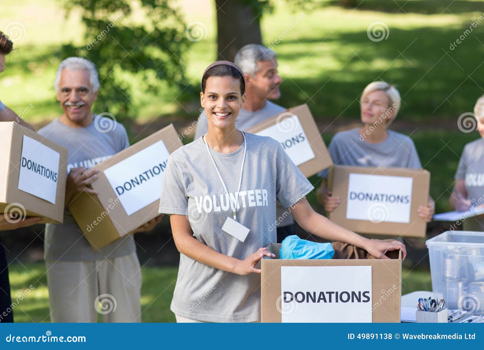 Happy Volunteer Brunette Smiling at the Camera Stock Photo - Image of ...