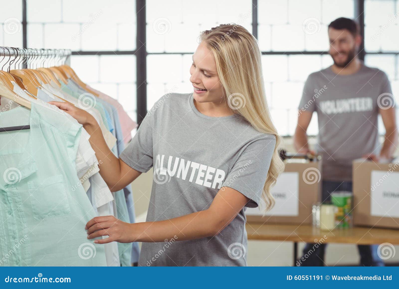 Happy Volunteer Choosing Clothes for Donation Stock Image - Image of ...