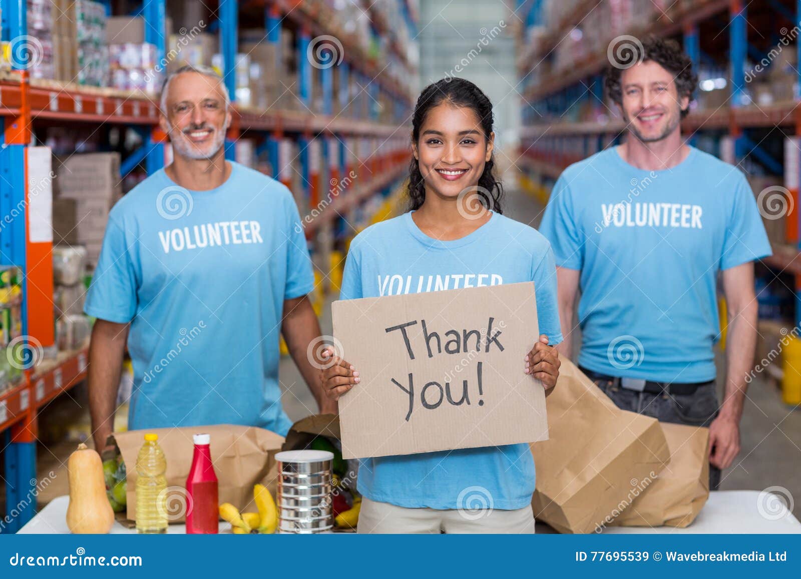 Happy Volunteer Holding a Sign and Posing with Her Team Stock Image ...