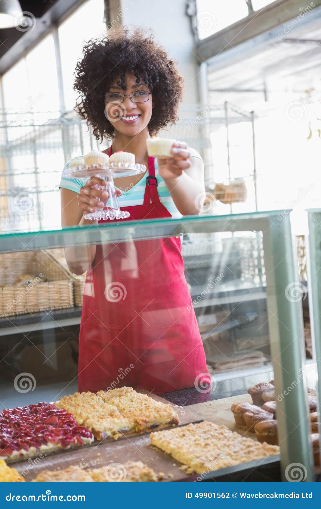 Happy Waitress in Red Apron Offering Cupcake Stock Photo - Image of ...
