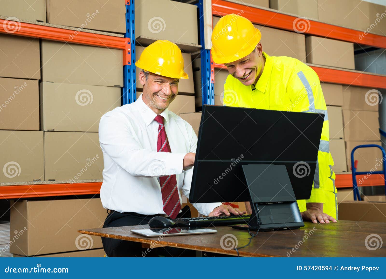 Happy Warehouse Worker and Manager Using Computer Stock Photo - Image ...