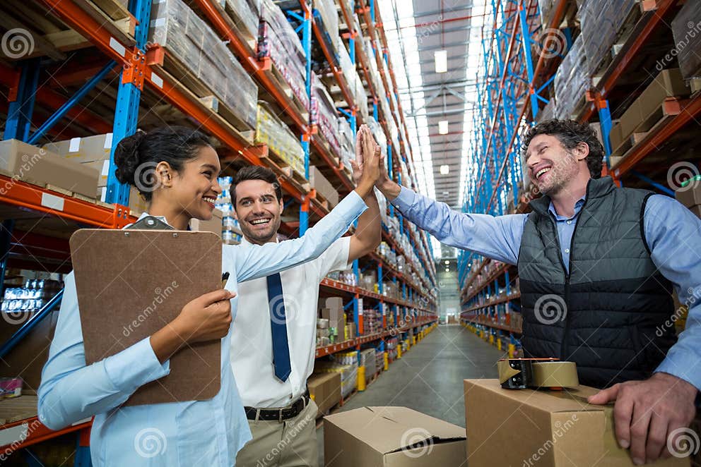 Happy Warehouse Workers Giving High Five Stock Image - Image of giving ...