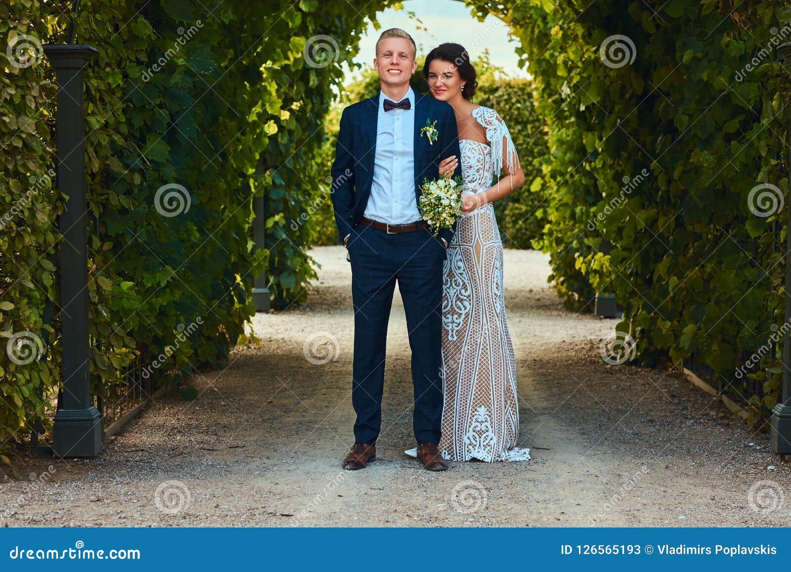 Happy Wedding Couple is Walking by a Beautiful Garden. Stock Image ...