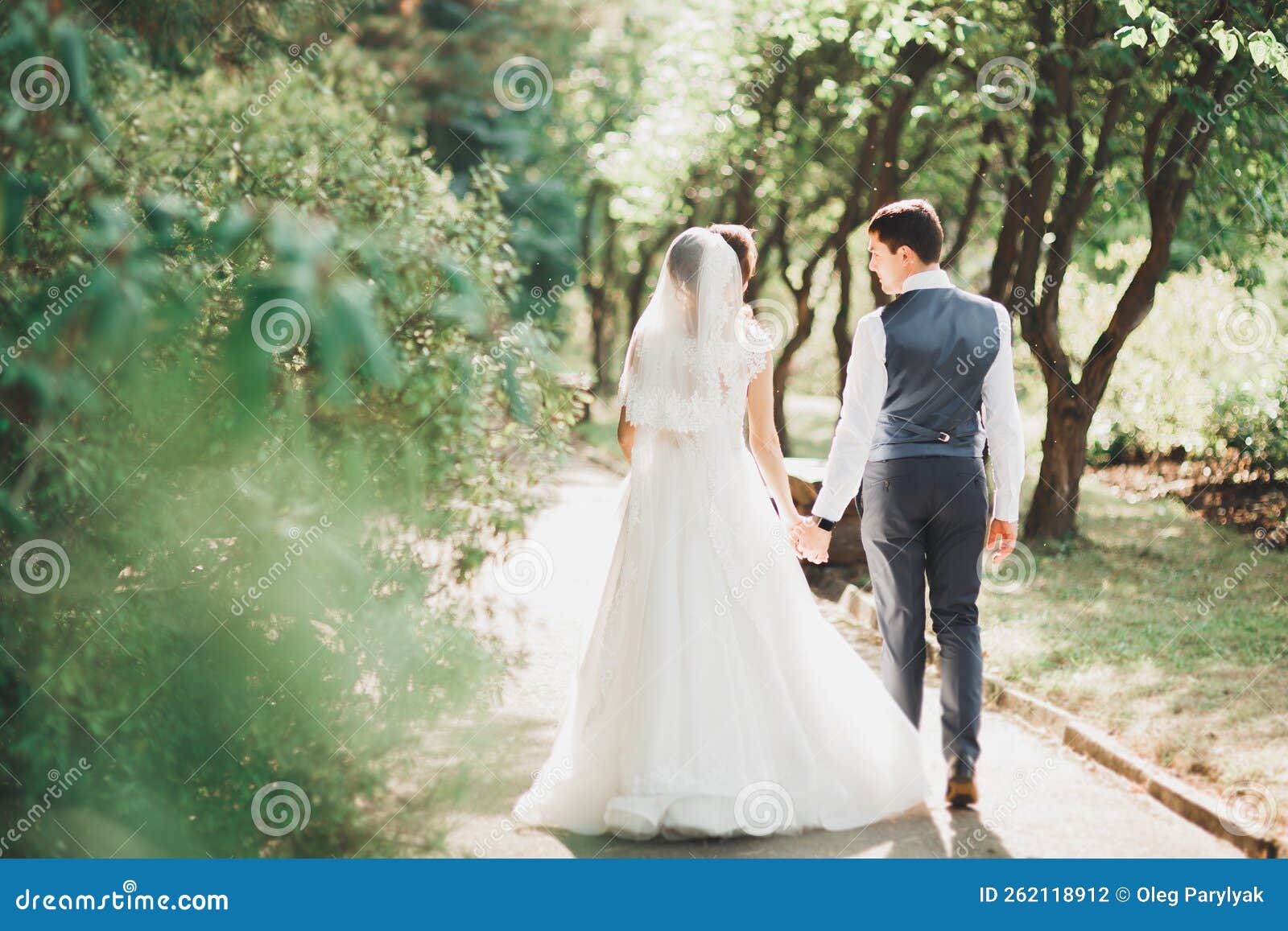 Happy Wedding Couple Walking in a Botanical Park Stock Photo - Image of bouquet, white: 262118912