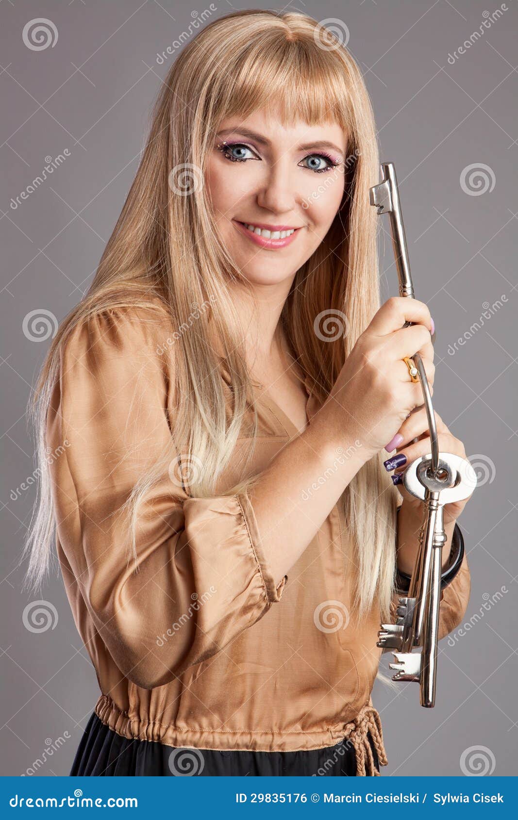 Happy woman with big keys stock photo. Image of smiling - 29835176