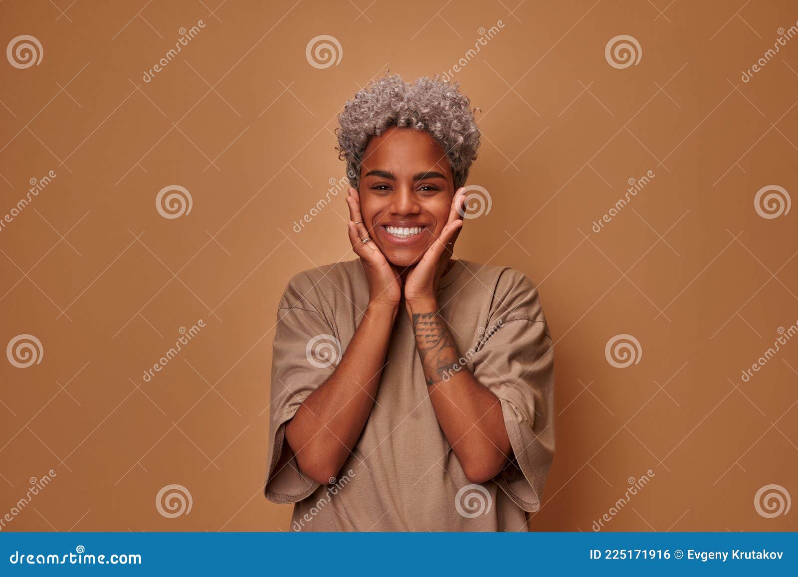 Happy Woman With Blonde Hair And Gentle Smile Holding Hands Under Chin