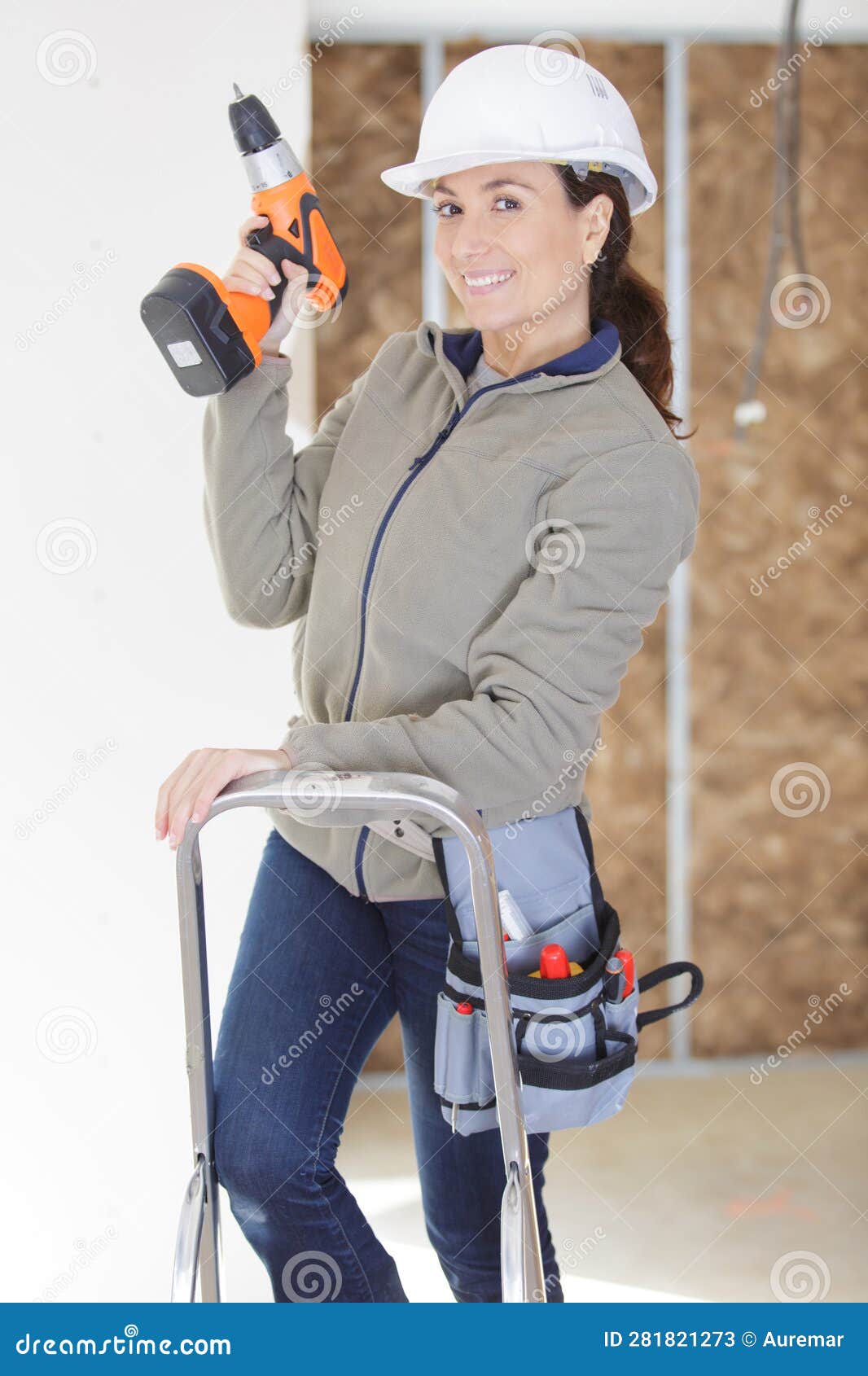 Happy Woman Builder Using Drill on Ladder Stock Image - Image of ...