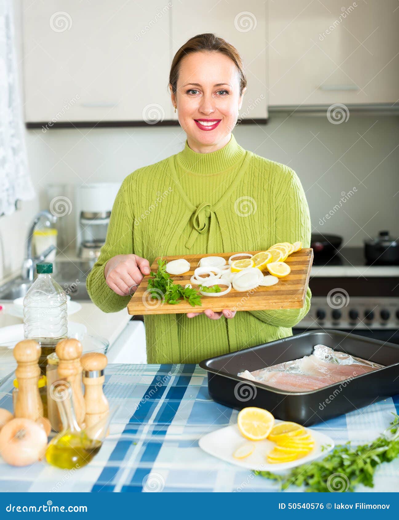 Happy woman cooking fish stock photo. Image of female - 50540576