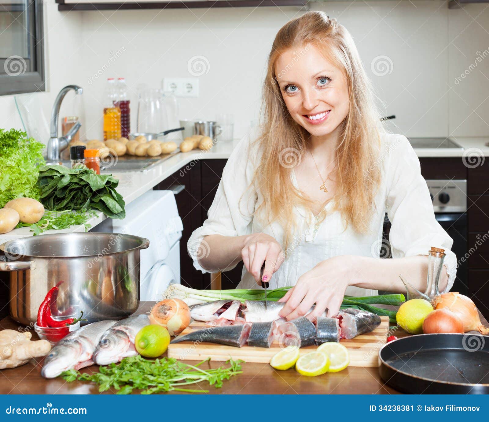 Happy woman cutting fish stock image. Image of female - 34238381