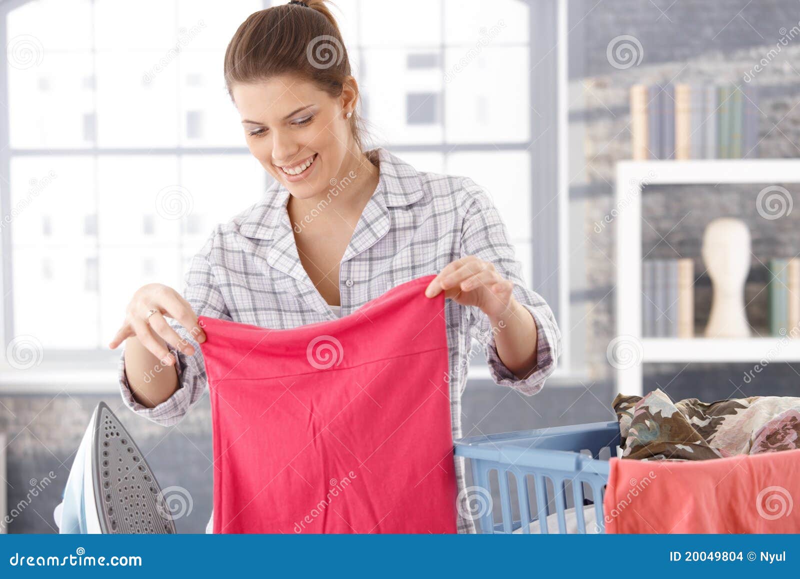 Happy woman doing laundry stock photo. Image of holding - 20049804