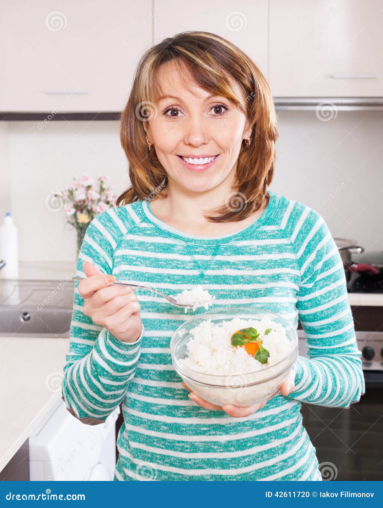 Happy woman eating rice stock photo. Image of domestic - 42611720