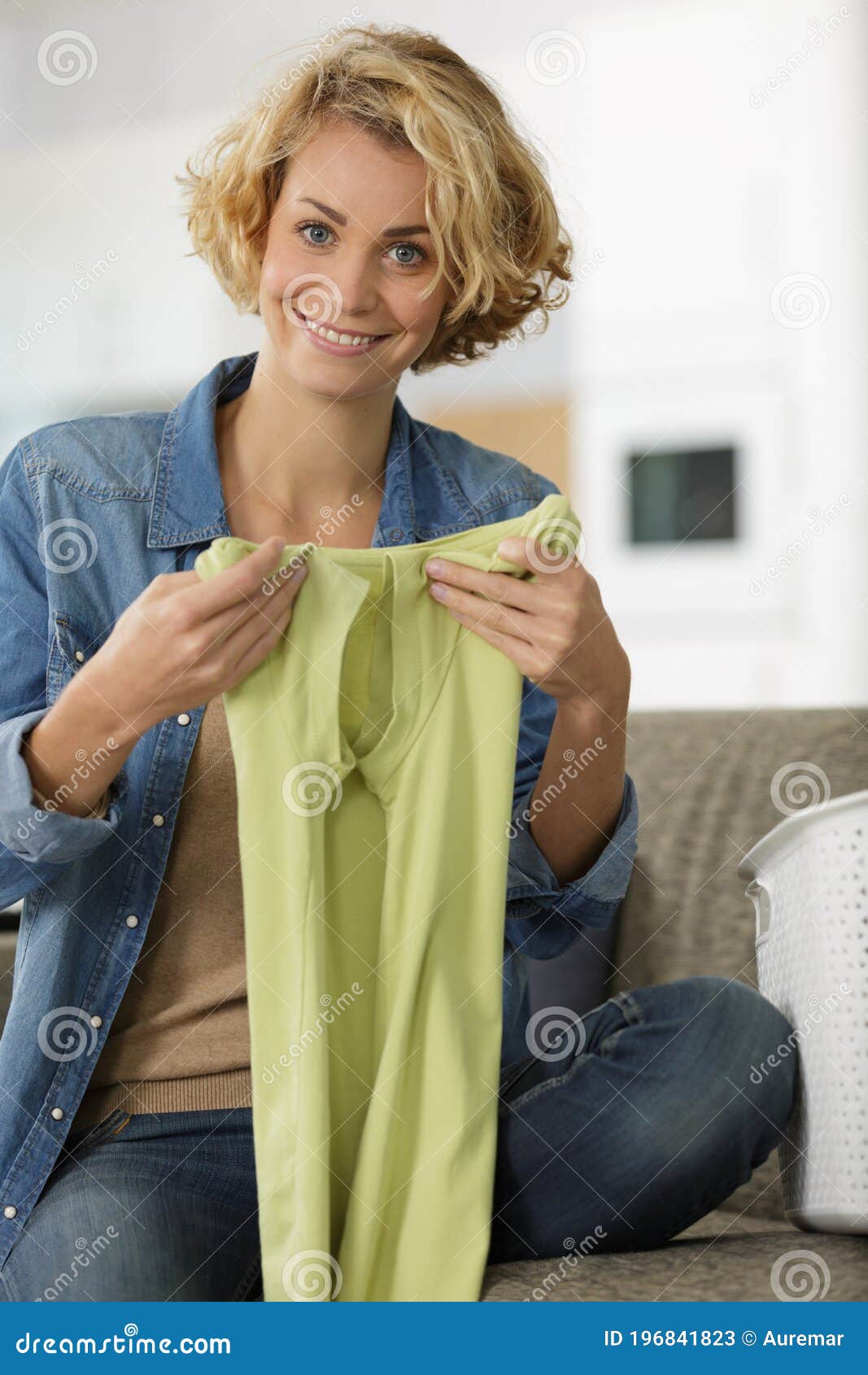 Happy Woman Folding Clothes Stock Image - Image of fabric, desk: 196841823
