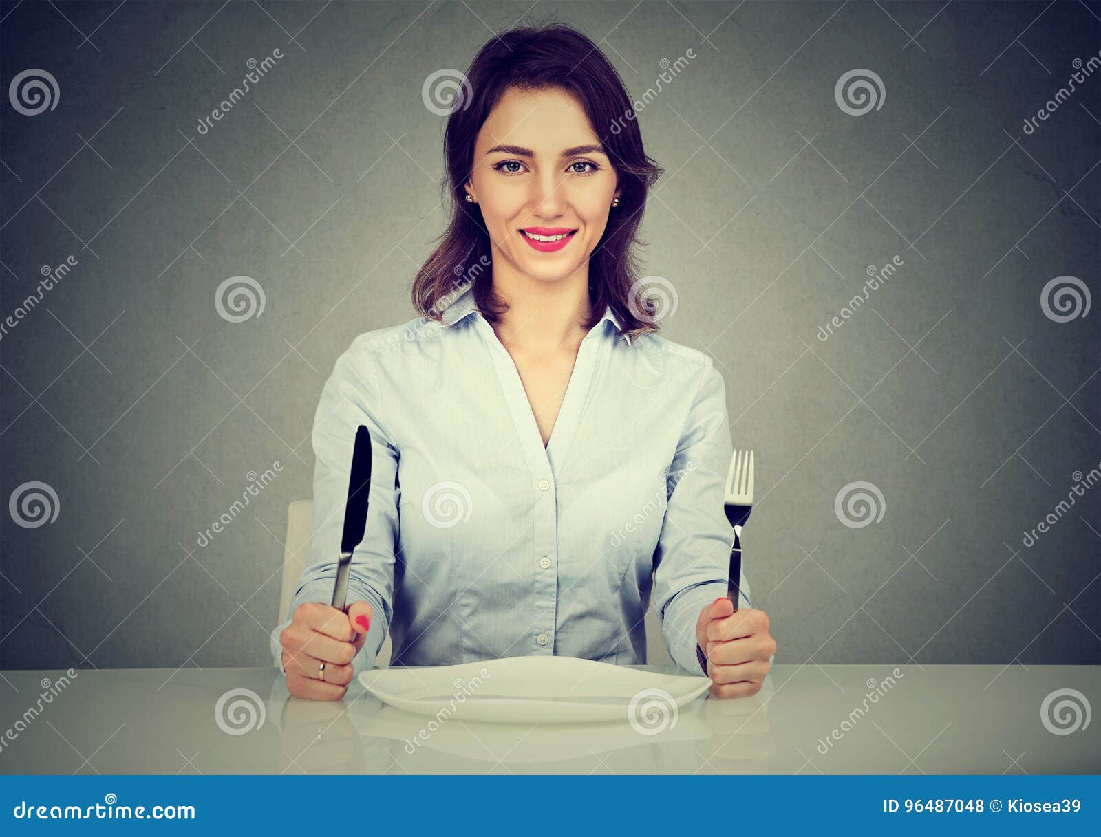 Happy Woman with Fork and Knife Sitting at Table with Empty Plate Stock ...