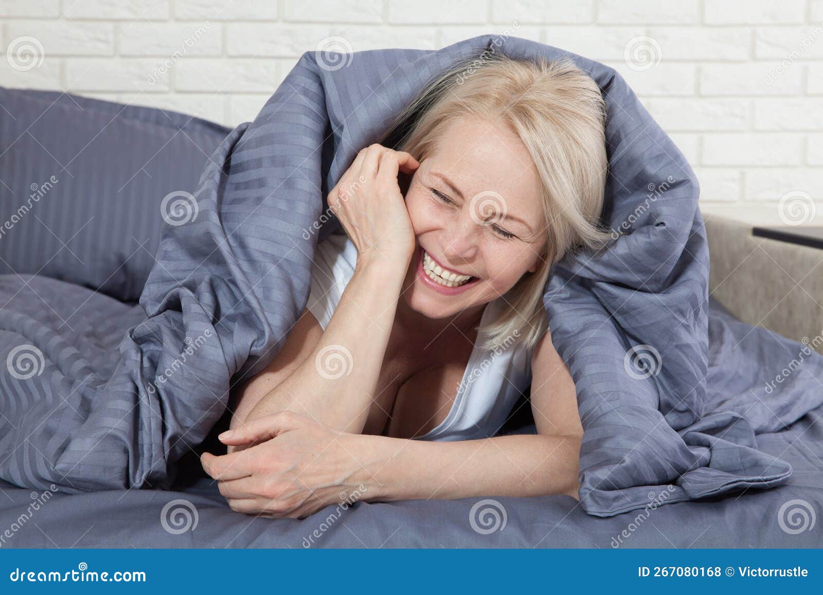 Happy Woman Hiding Under the Duvet in Bed Stock Photo - Image of duvet ...