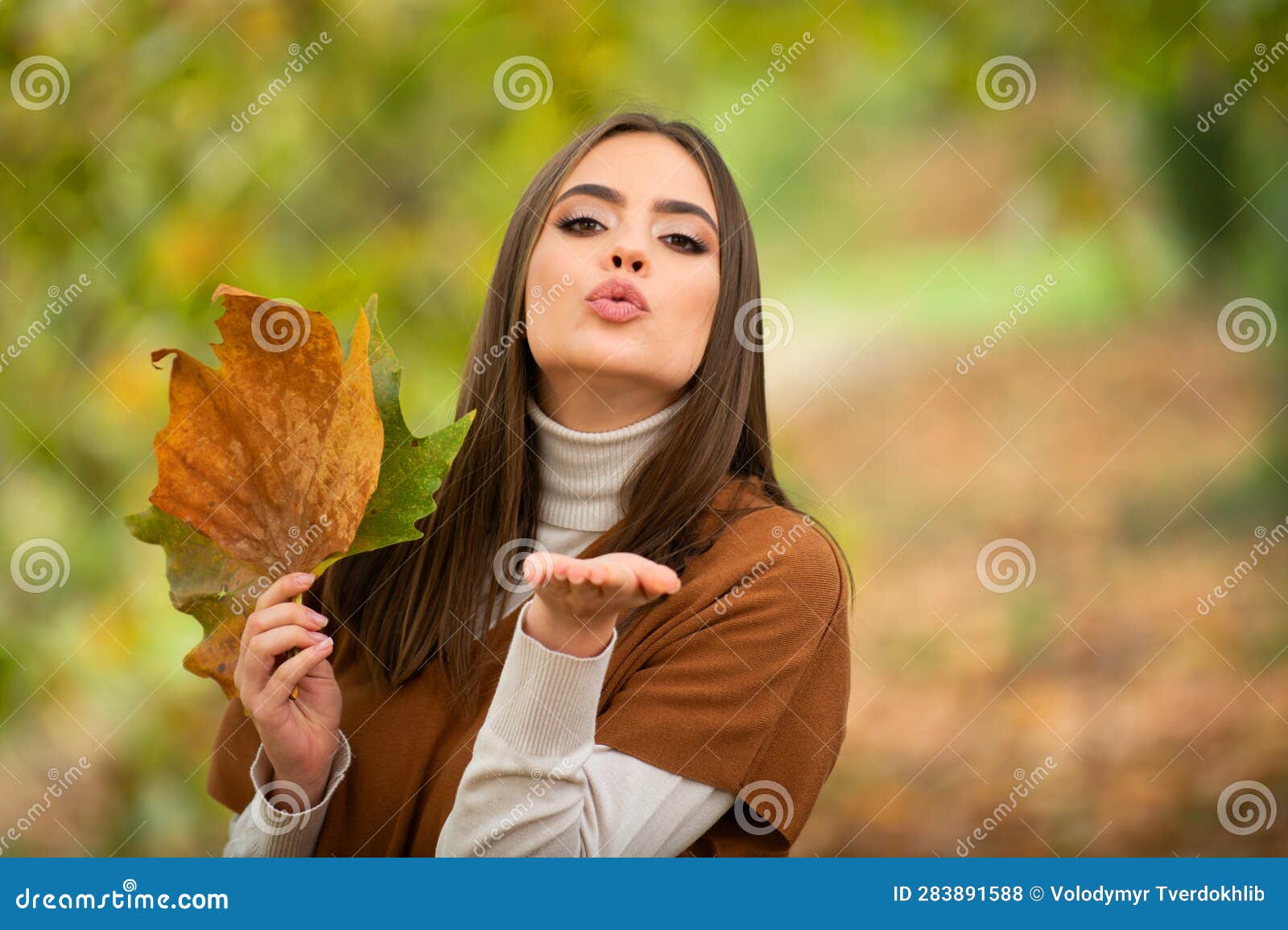 Happy Woman Holding Autumn Leafs On Face In Fall Nature Portrait Of
