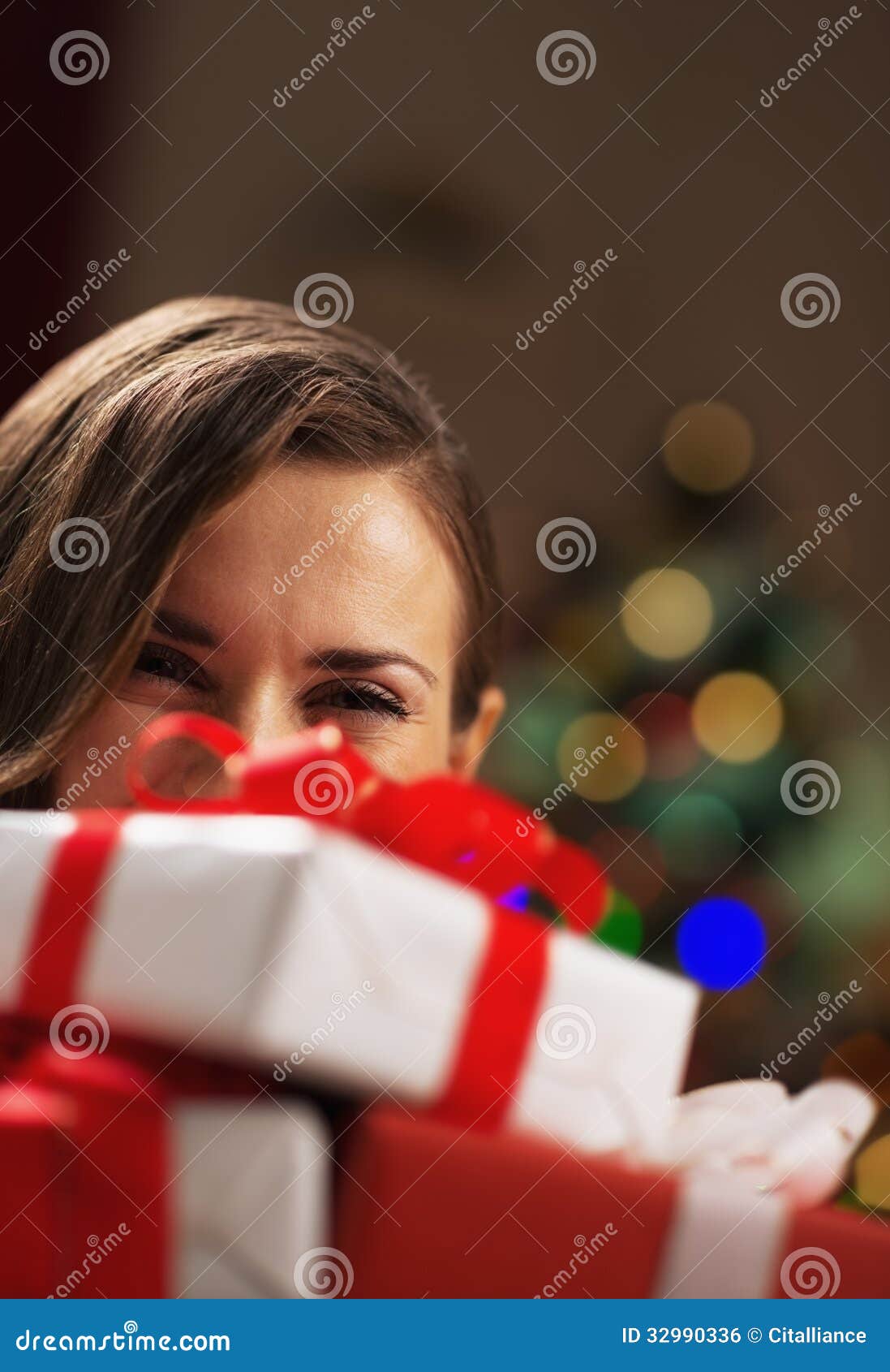 Happy Woman Holding Christmas Present Boxes in Front of Face Stock ...