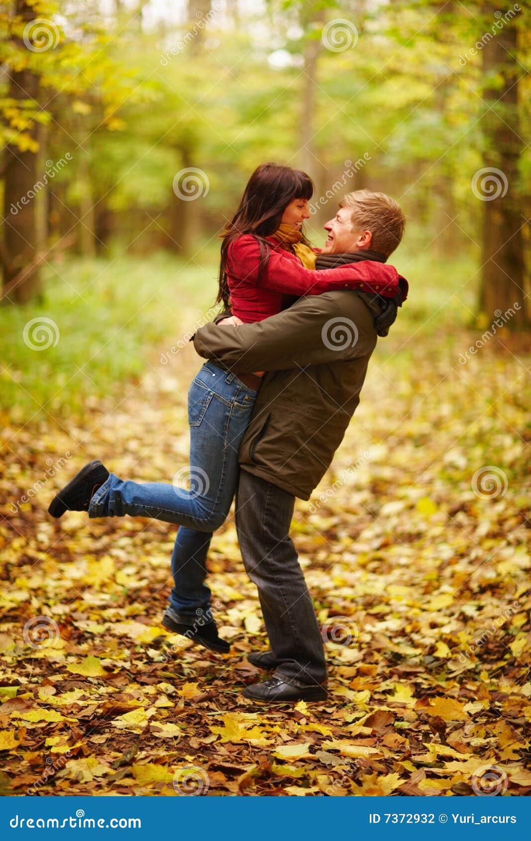 Happy Woman Jumping into Mans Arms in Forest Stock Photo - Image of ...