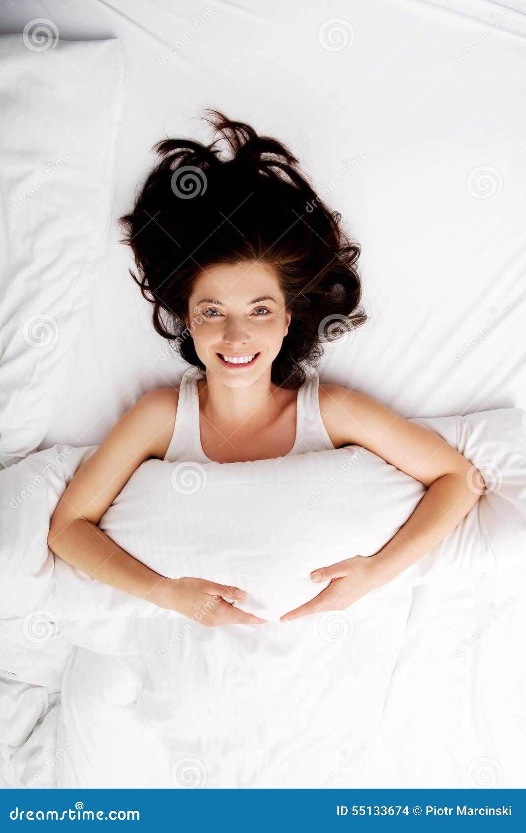 Happy woman lying in bed. stock photo. Image of rest - 55133674