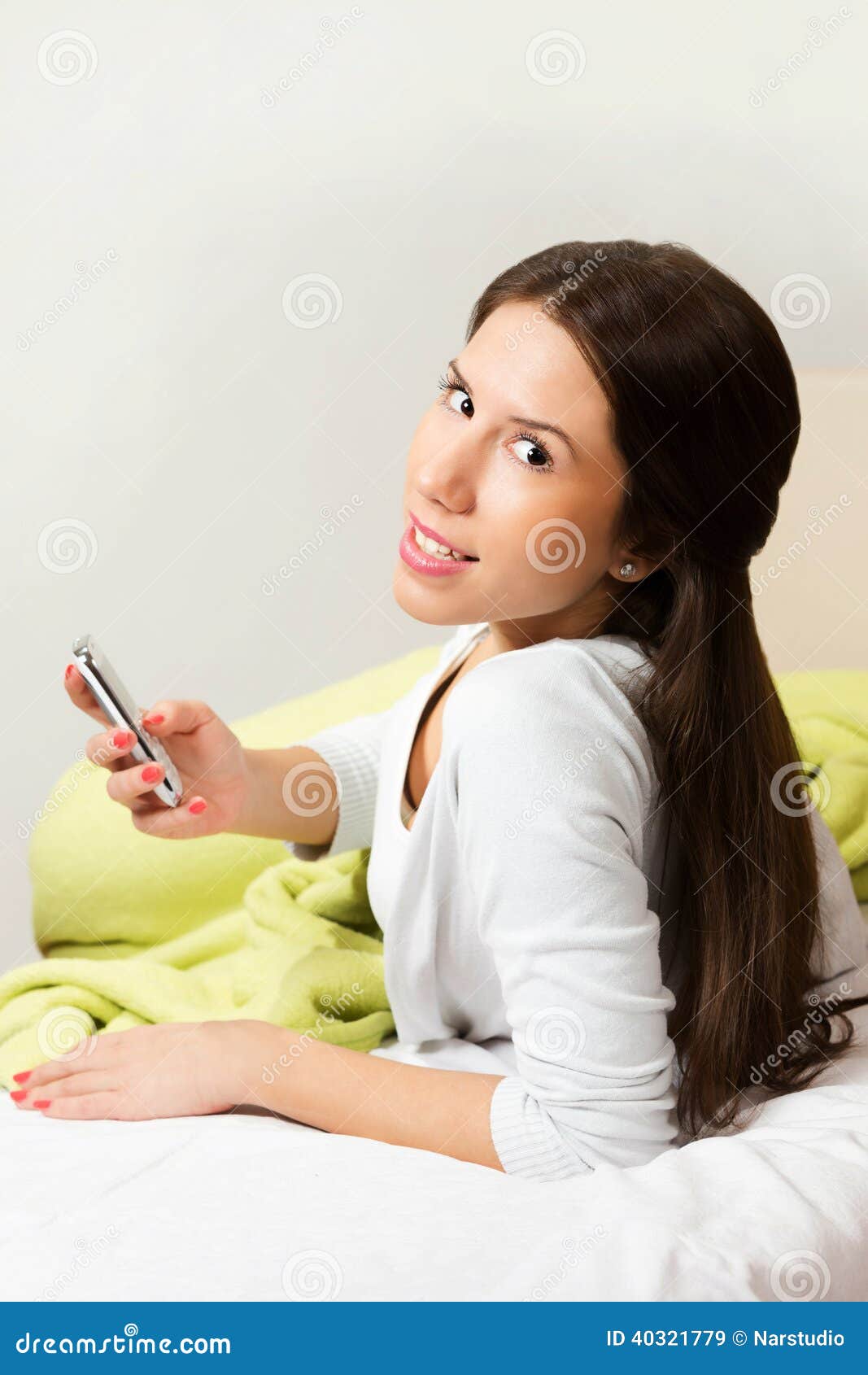 Happy Woman Lying on Bed Smiling, Reading a Text Message Stock Image ...