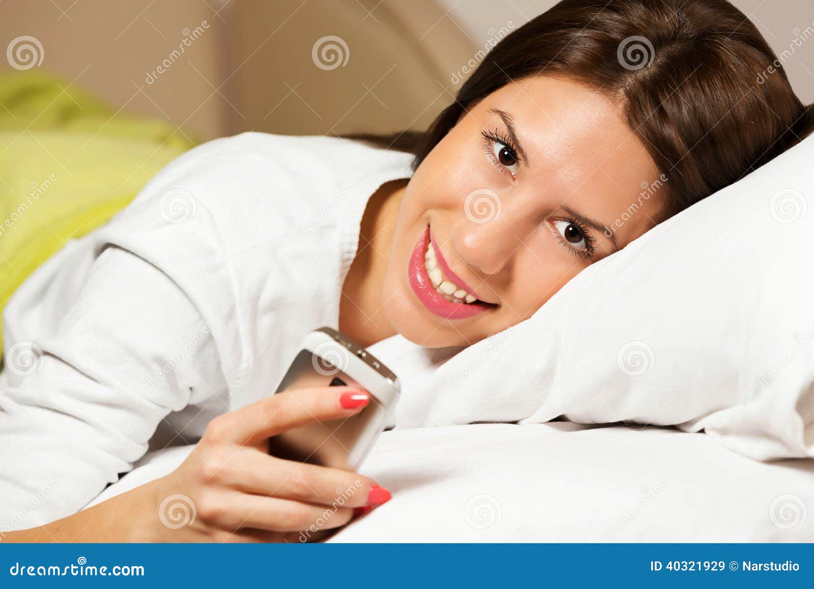 Happy Woman Lying on Bed Smiling, Reading a Text Message Stock Image ...