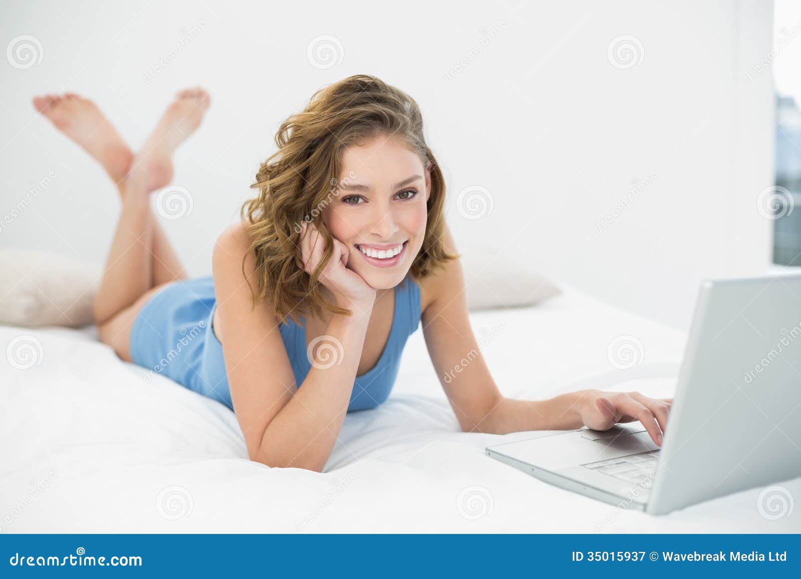 Happy Woman Lying on Her Bed Working with Her Notebook Stock Image ...